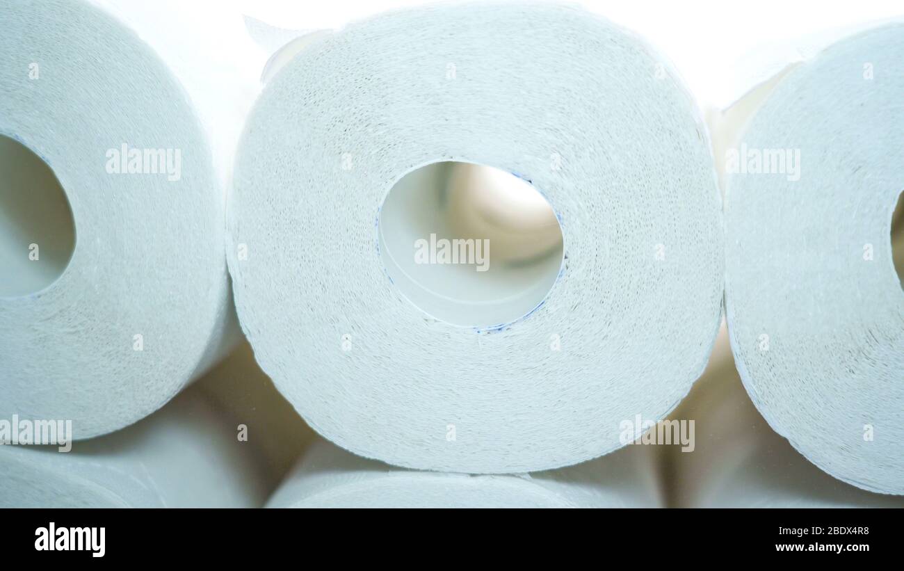 Rolls of the bathroom tissue paper in the table with the white sheets ...