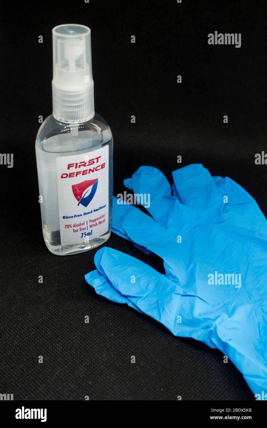Hand Sanitiser and a pair of rubber gloves defence against bacteria and ...