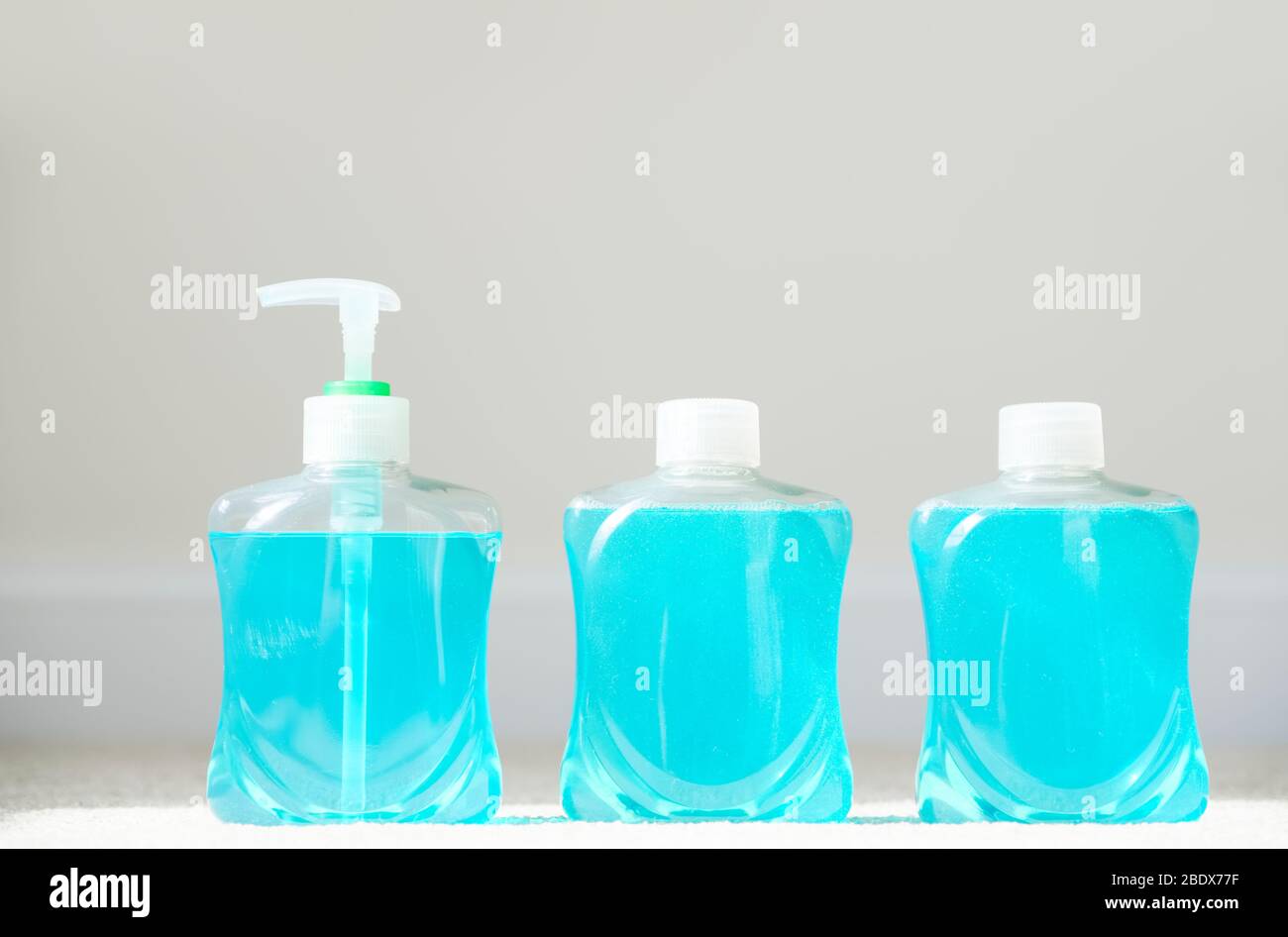 Hand wash blue gel in dispenser on bathroom basin for clinical ...