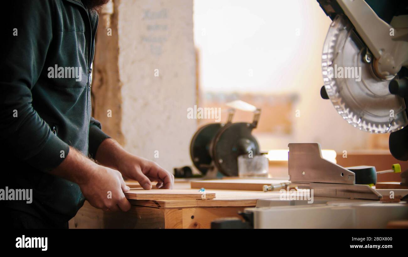 Carpentry working - a man making marks on the plywood. Mid shot Stock ...