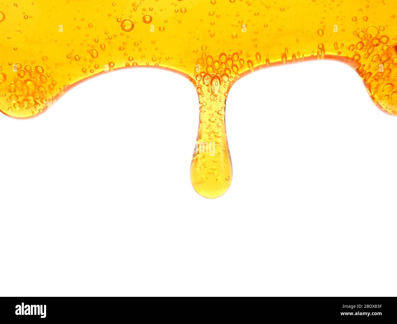 Flow of sweet honey on the white background Stock Photo - Alamy