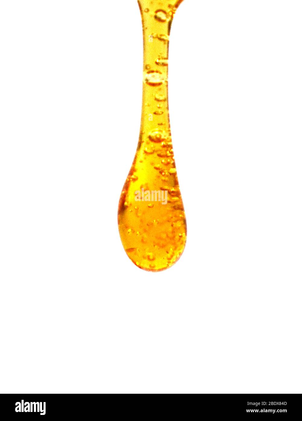 Flow of sweet honey on the white background Stock Photo - Alamy