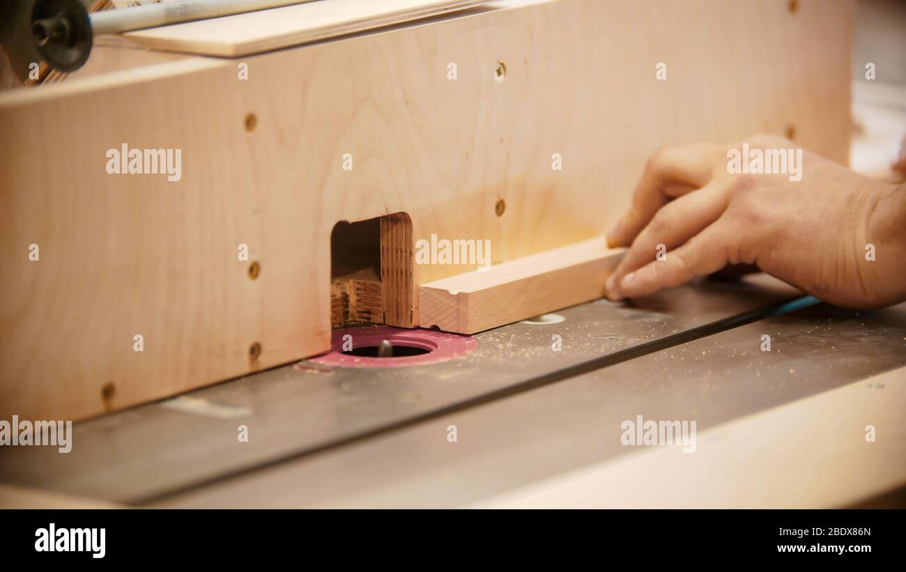 Carpentry working - hands of man worker make a hemisphere cut out in ...