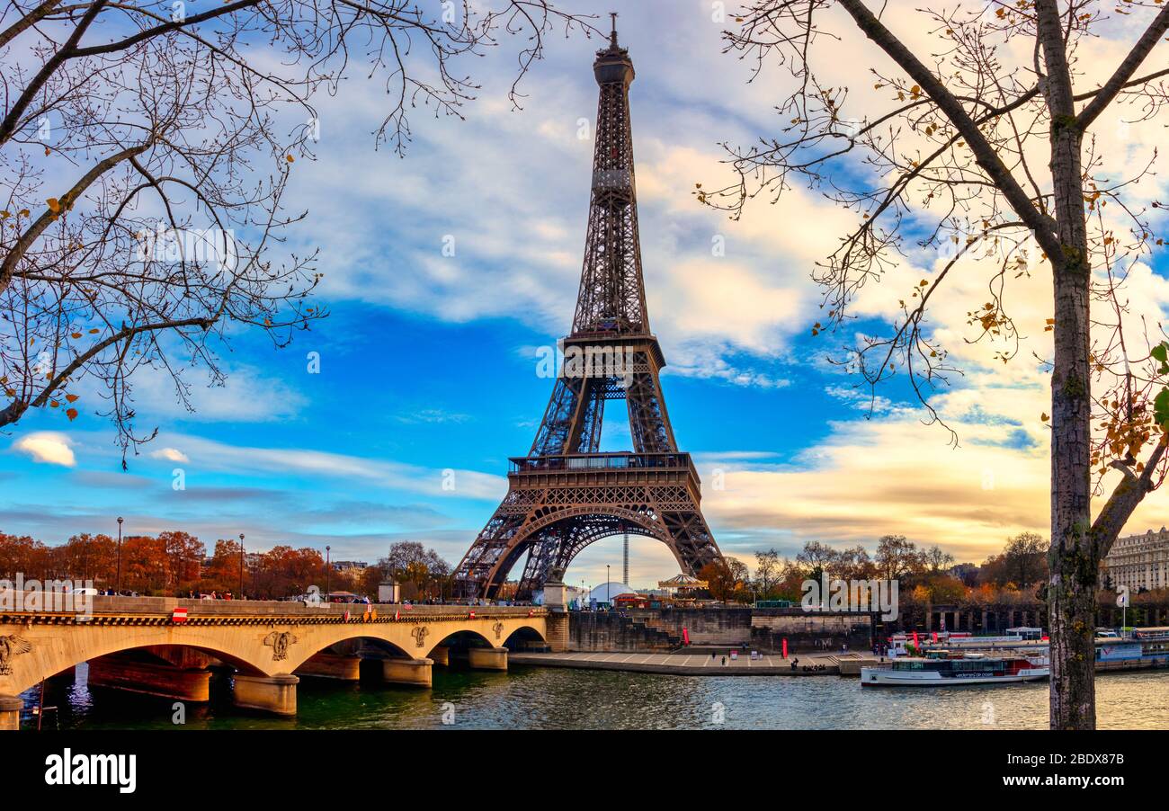 CItyscape of Paris in fall. Ships and brigde over Seine river with ...