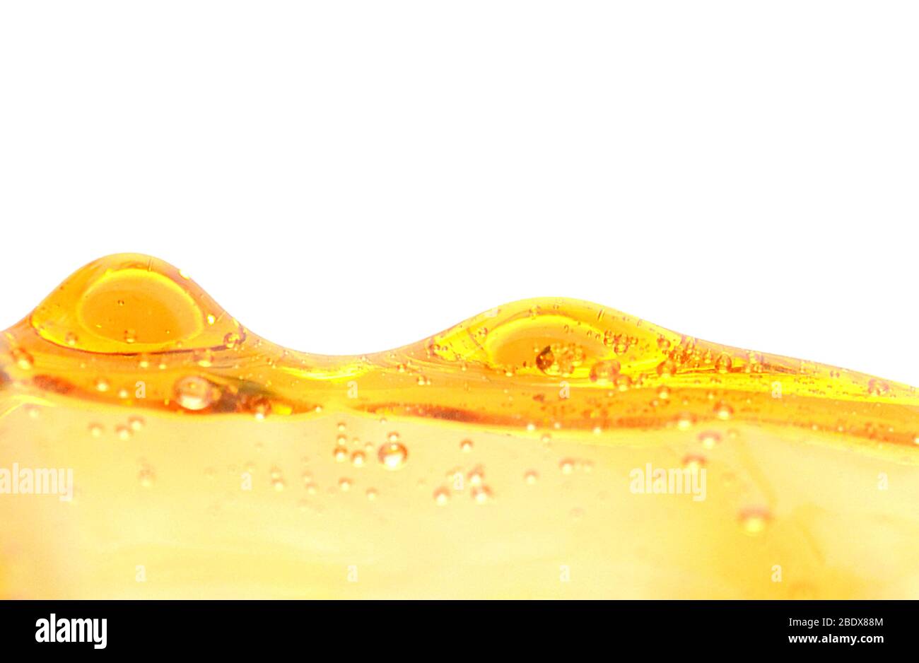 A stream of golden honey and a pool on a white background Stock Photo ...