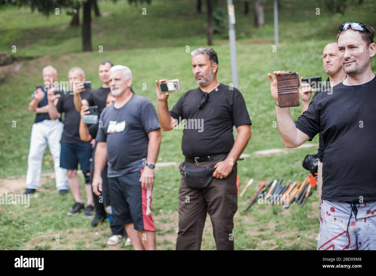 Large group of people use mobile cellphone phone to video record ...