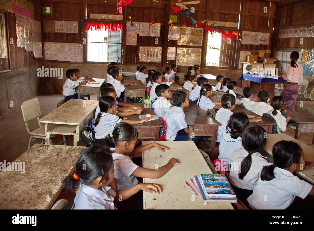 Pupils sitting in schools benches Stock Photo - Alamy