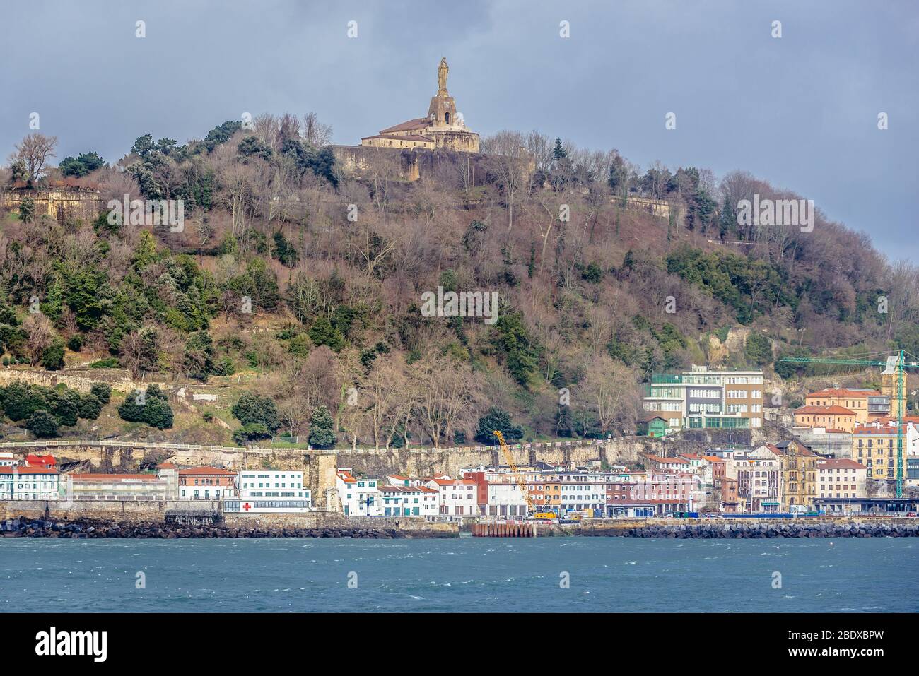 Urgull mount with Jesus Christ statue over La Concha Bay in San ...
