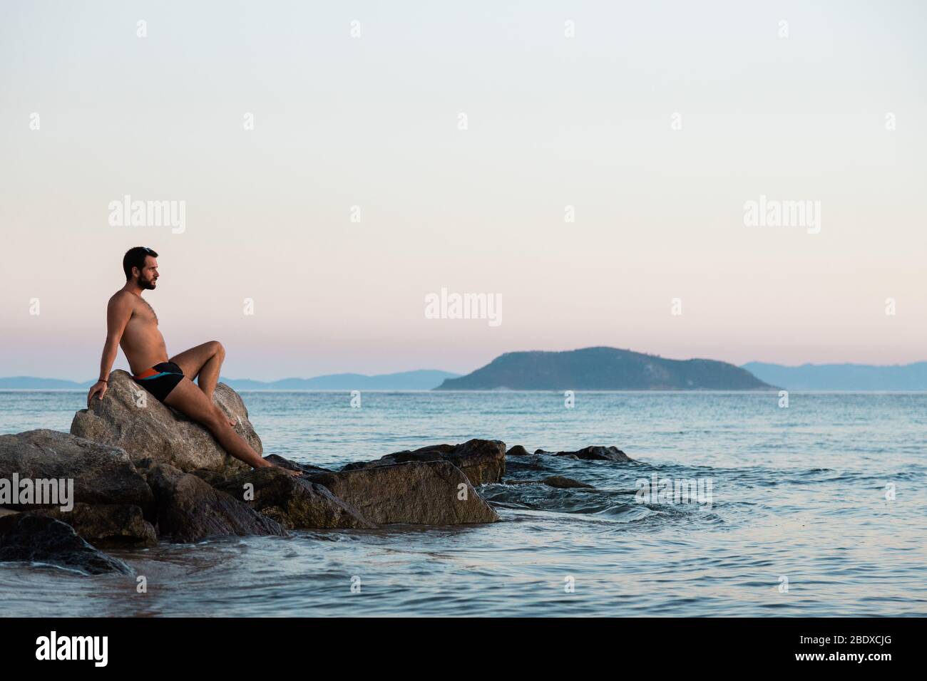 Young man watching beautiful sunrise hi-res stock photography and ...