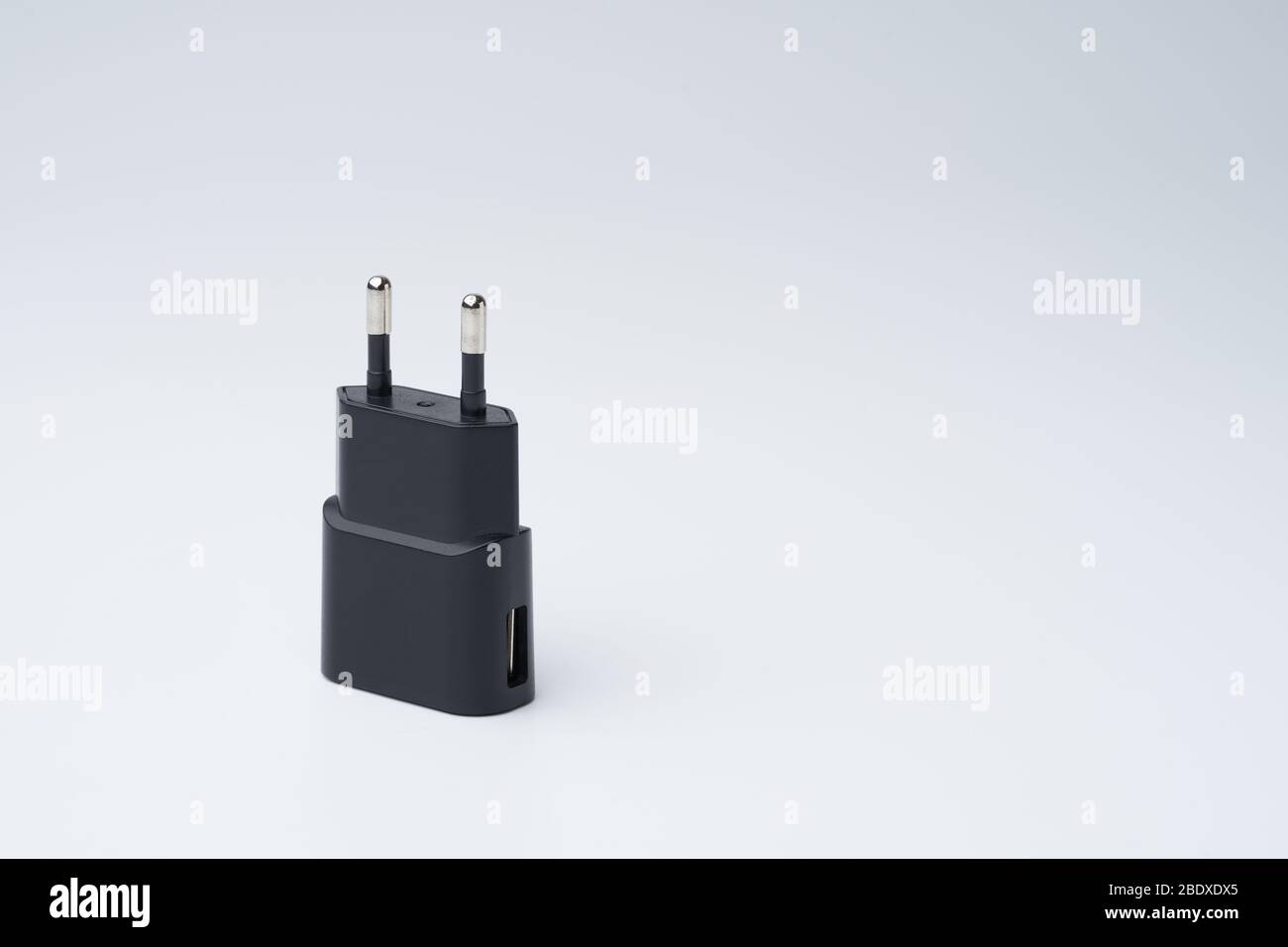 Black USB power adapter for smartphone isolated on white background ...
