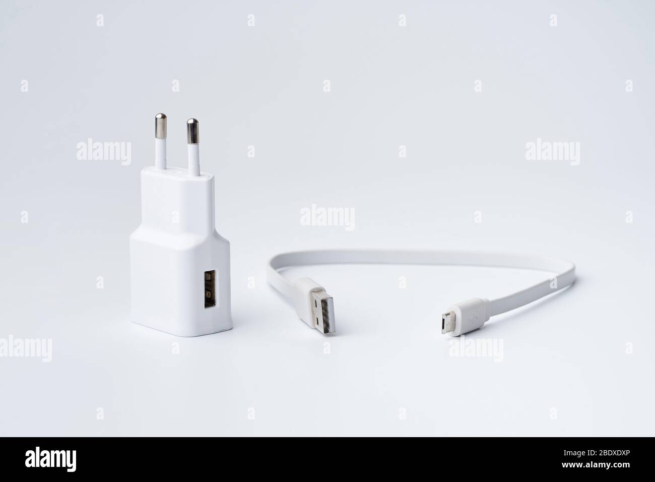 White USB power adapter and cable for divice isolated on a white ...