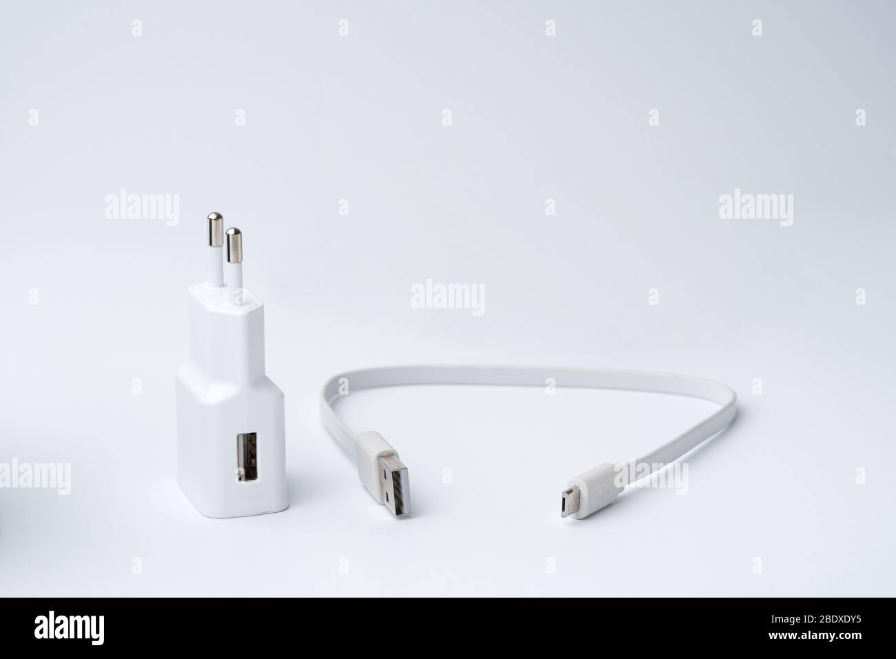 White USB power adapter and cable for divice isolated on a white ...