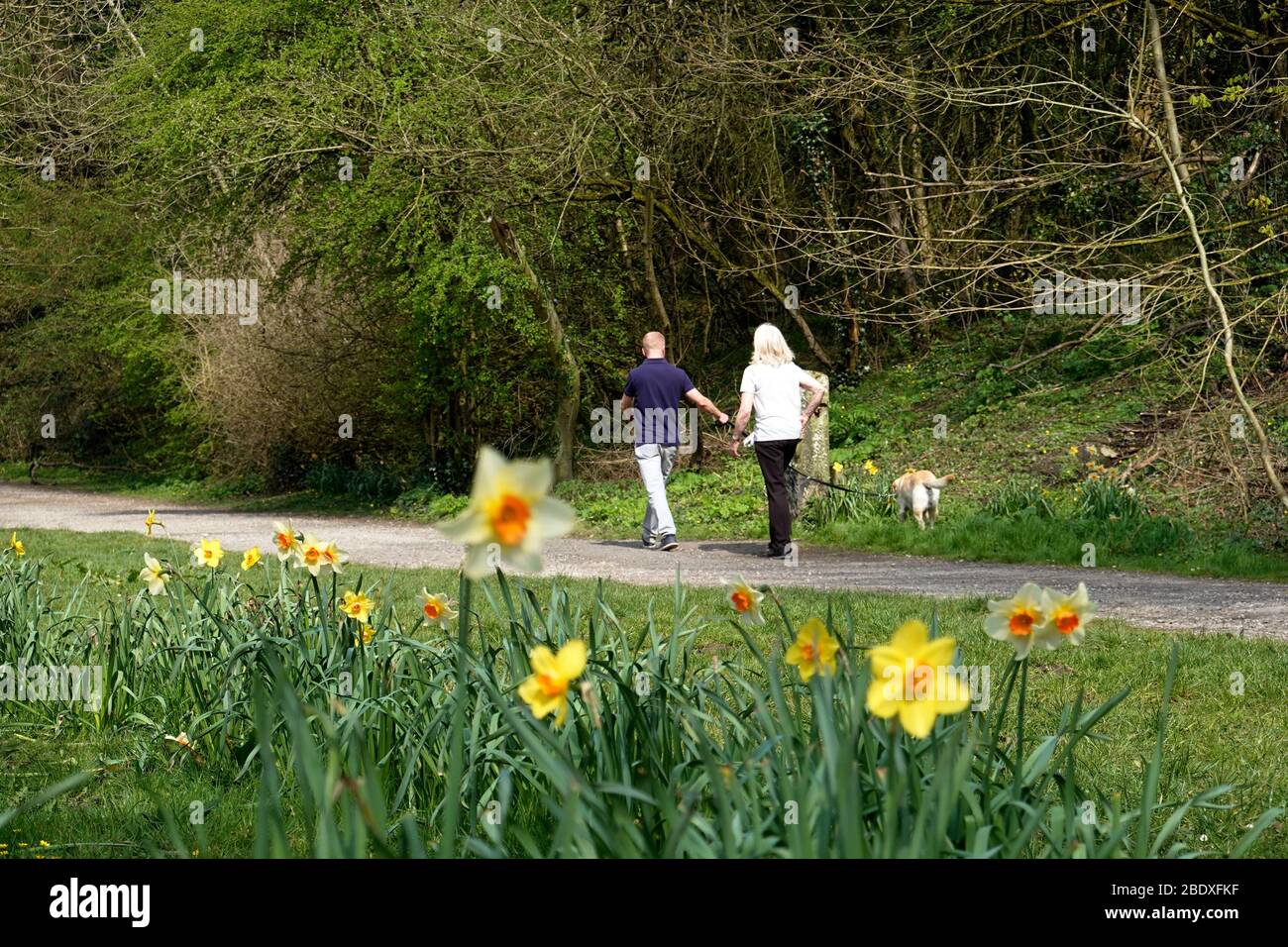 People walk along the path by the River Got in New Mills, Derbyshire ...