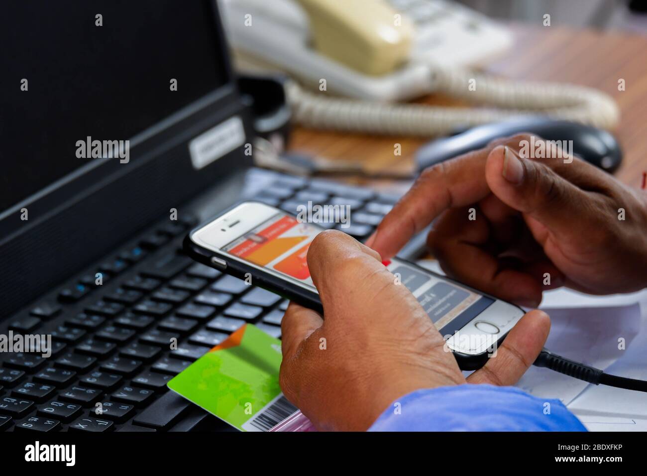 The hand is pressing the phone at work Stock Photo - Alamy