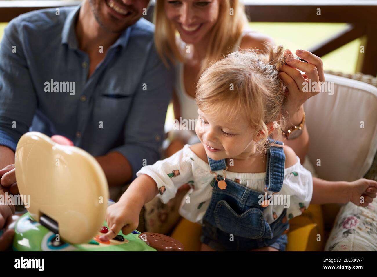 Cute little girl having fun with toy Stock Photo - Alamy