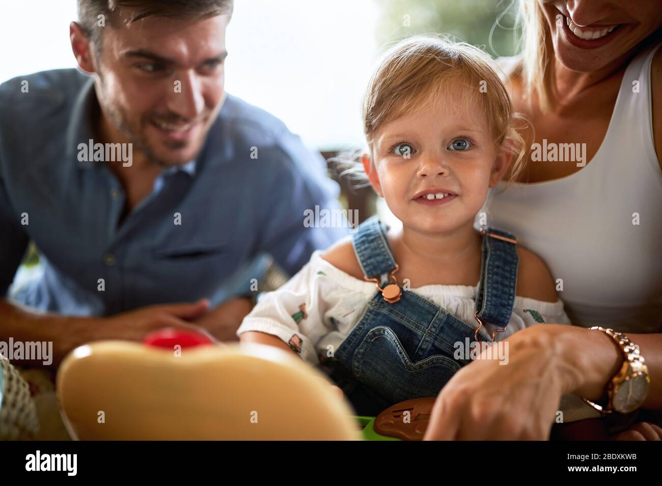 Cute female child with parents together enjoy Stock Photo - Alamy