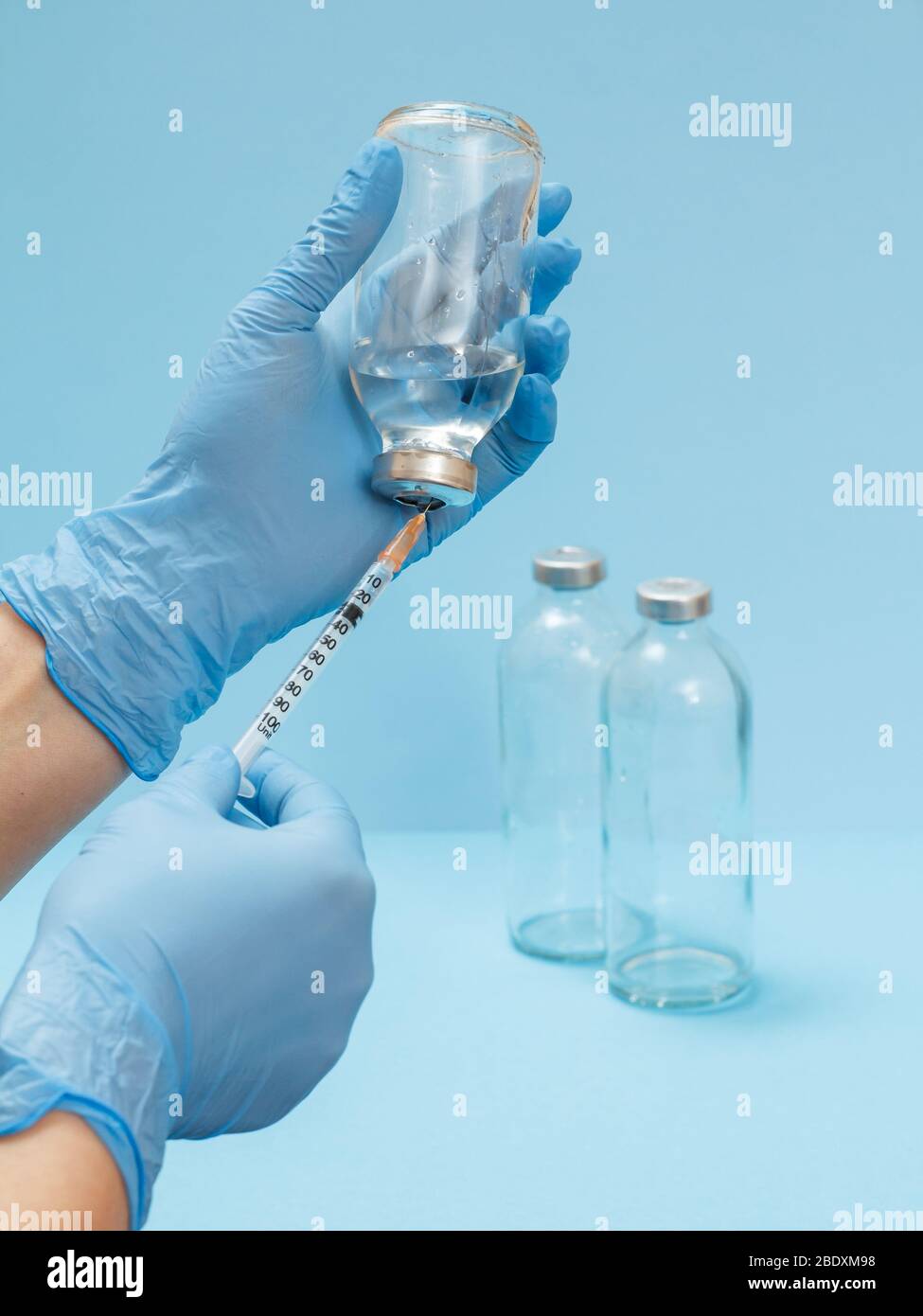 Doctor picking up medication syringe hi-res stock photography and ...