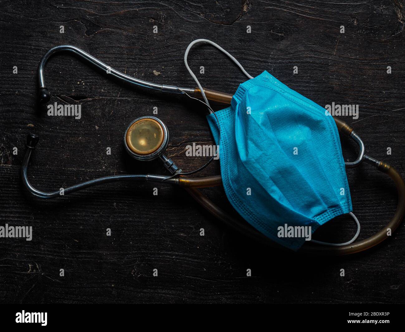 Coronavirus, stethoscope, surgical mask, pills on a black white ...