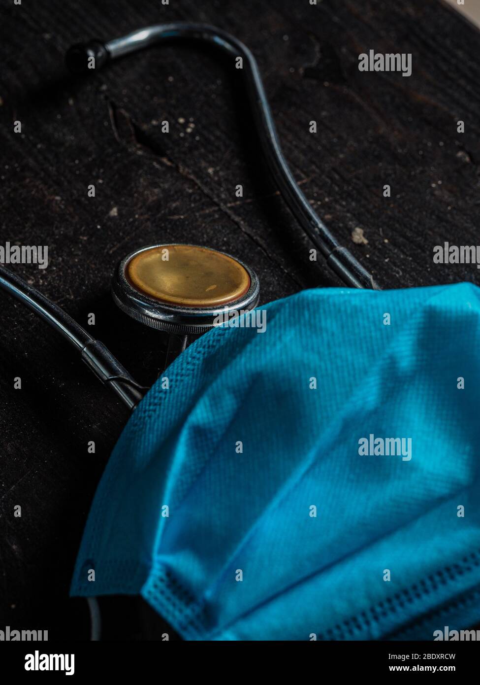 Coronavirus, stethoscope, surgical mask, pills on a black white ...