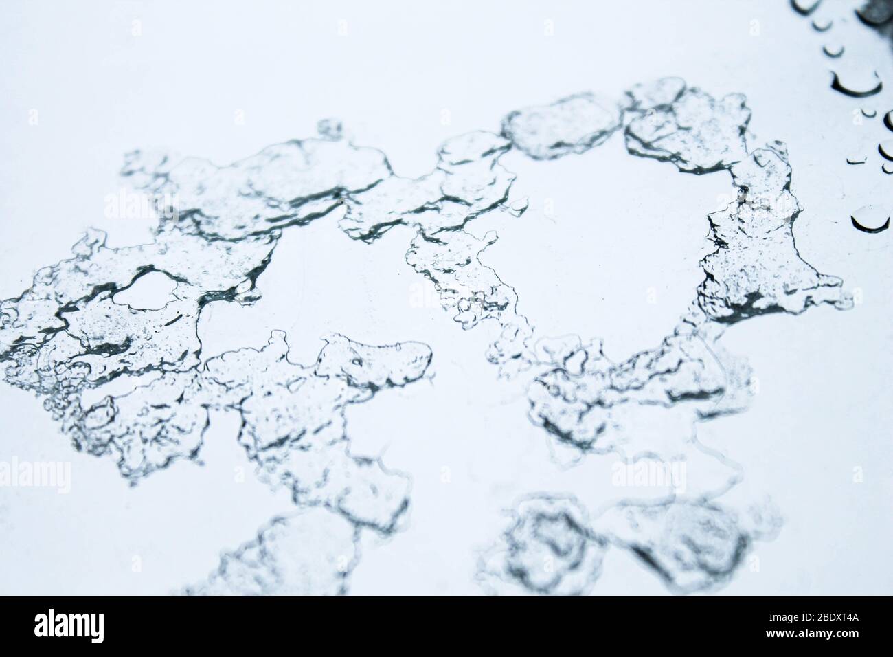 Snow on the window. Frozen and melted snow on the glass Stock Photo - Alamy