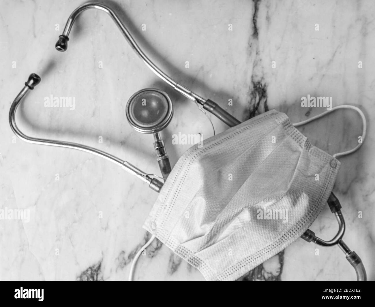 Coronavirus, stethoscope, surgical mask, pills on a black white ...