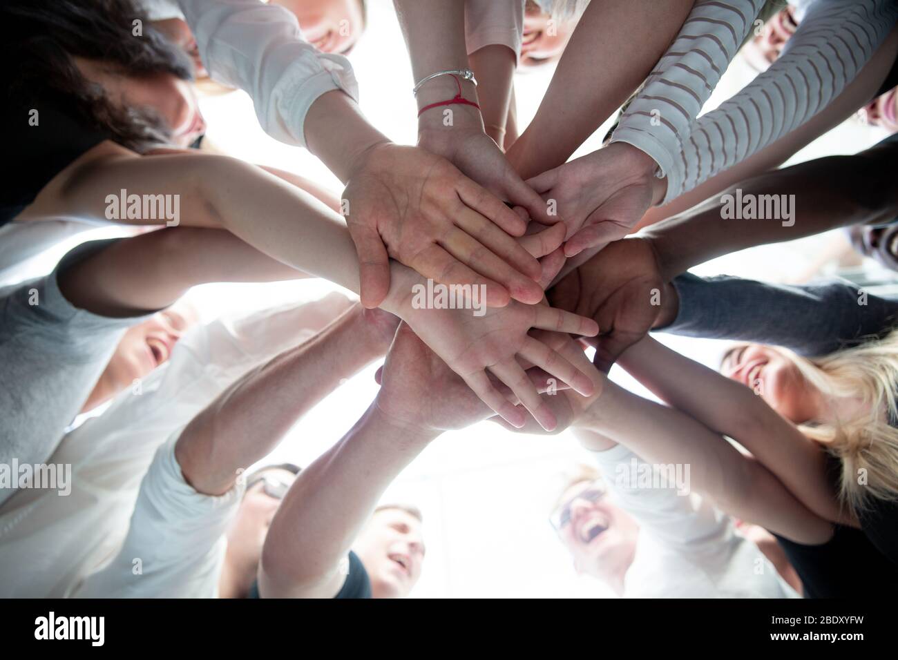 bottom view . group of young people joining their palms together Stock ...