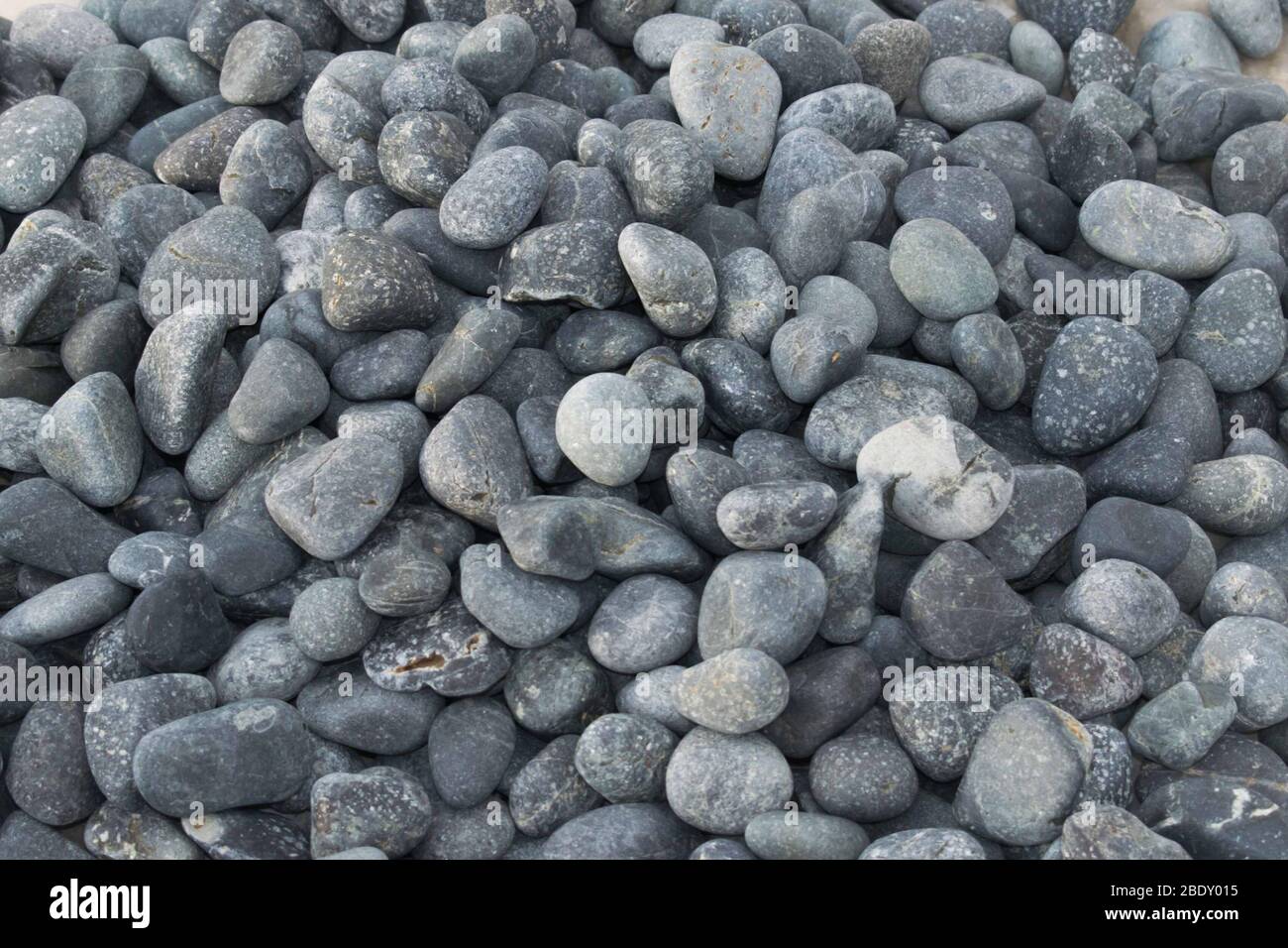 Piled gray cobble stones. Beach rocks Stock Photo - Alamy