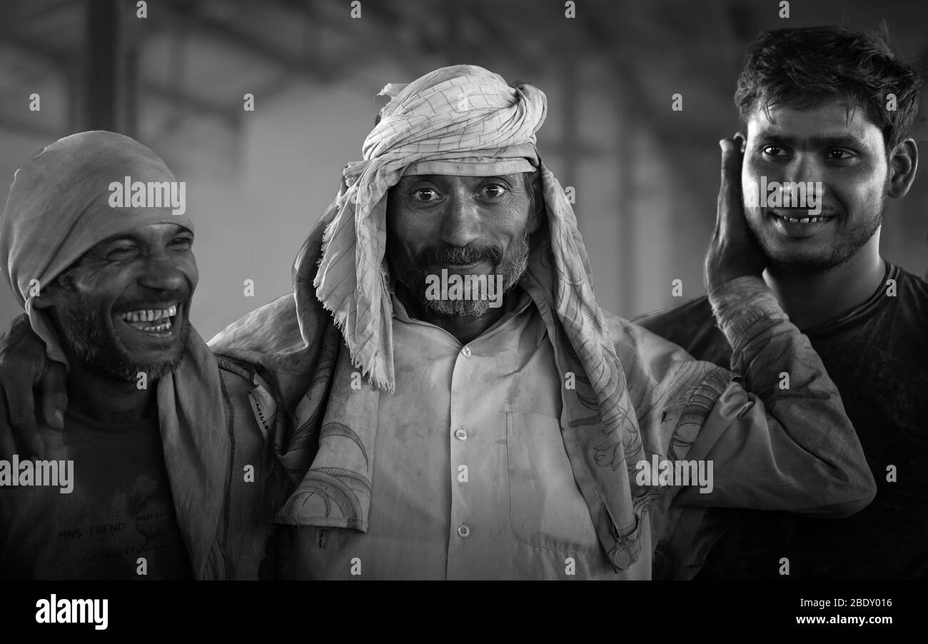 Portrait of men wearing only head scarf as protection employed to move ...