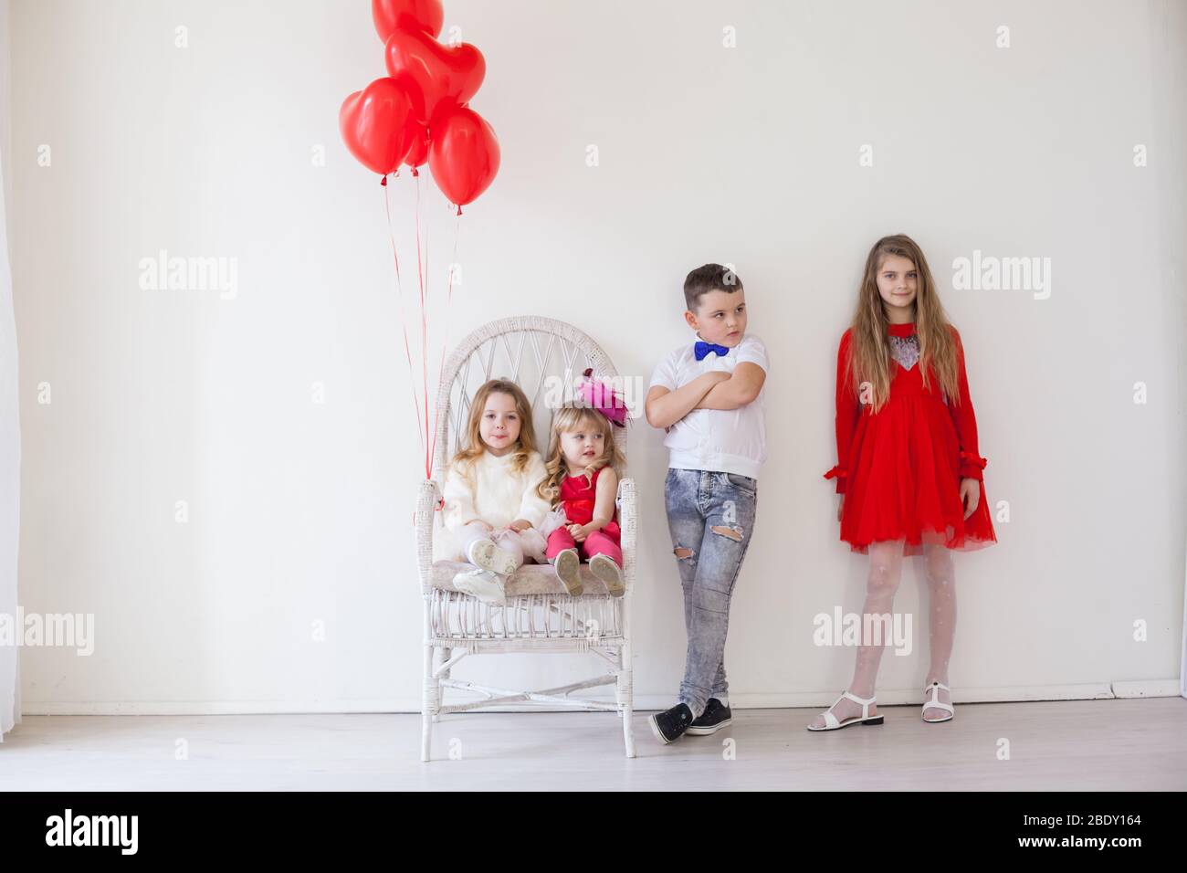 Kids with red balloons for birthday in the interior Stock Photo - Alamy
