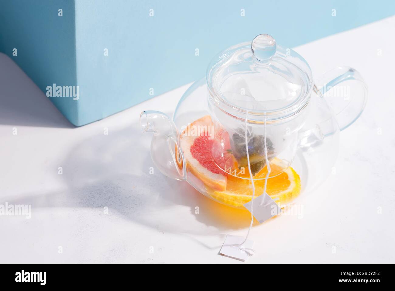 Glass teapot with cold natural summer homemade fruit tea drink and ...