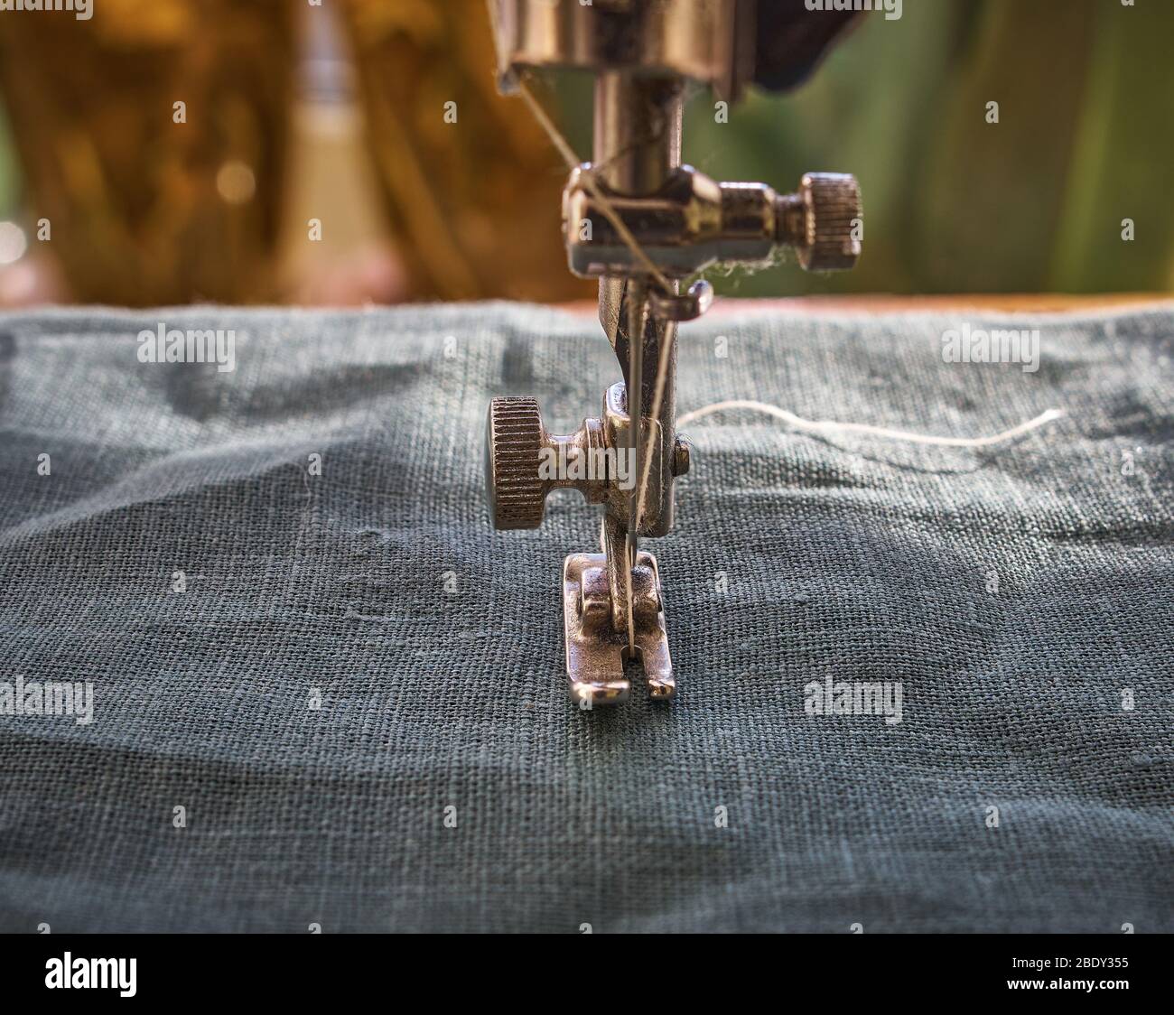 Closeup the sewing machine and item of clothing, old sewing machine ...