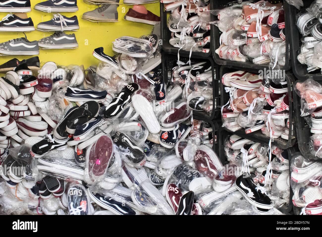 Stacked messy shoes on the shelf Stock Photo - Alamy