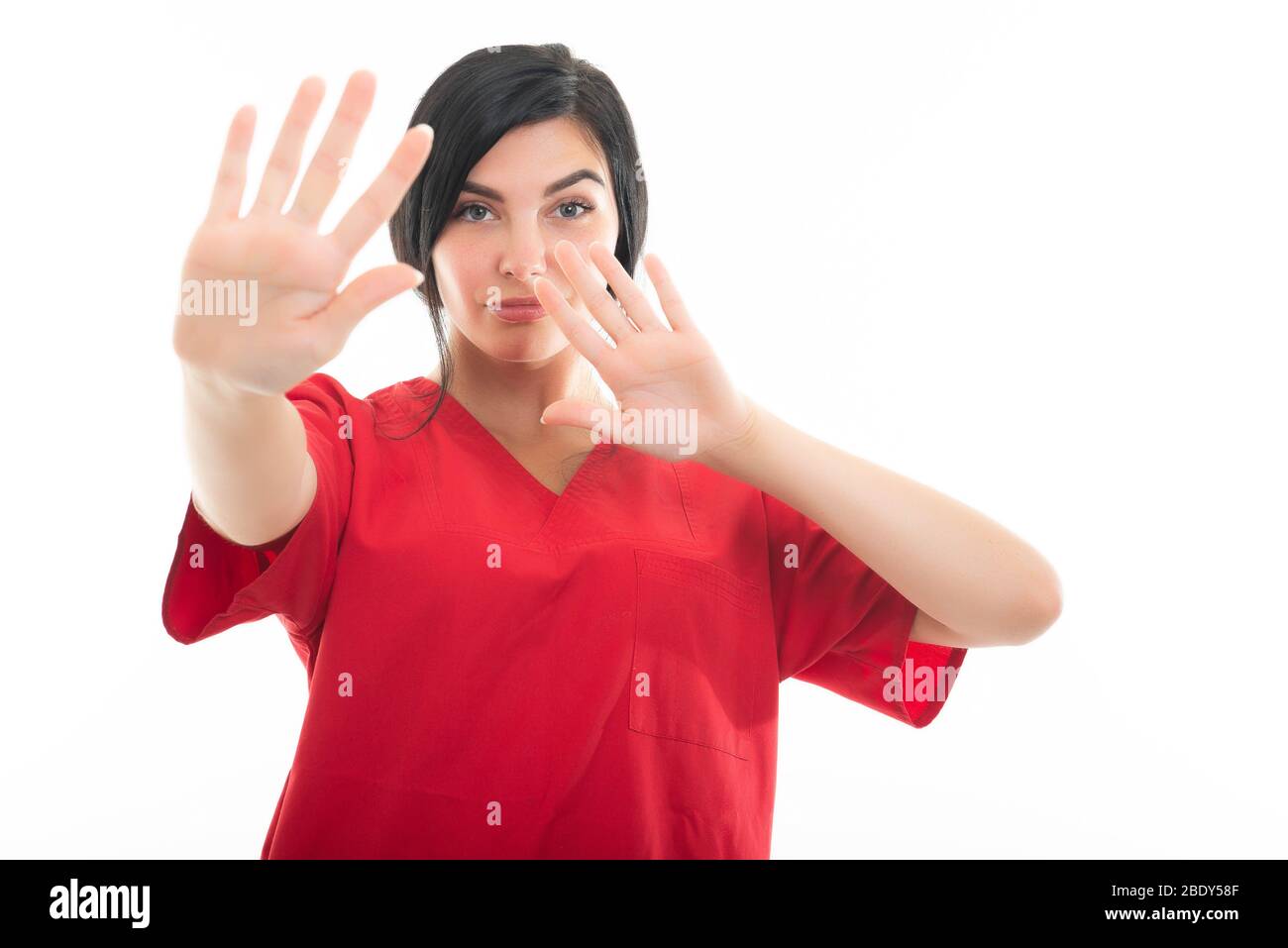 Portrait of young attractive female nurse making defense gesture ...