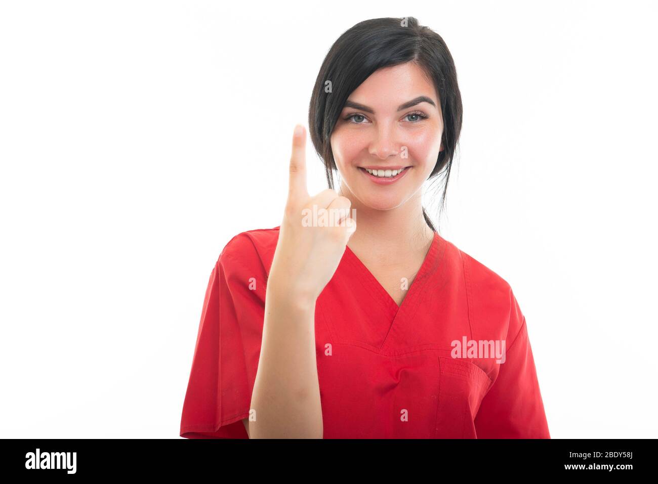 Portrait of young attractive female nurse showing number one isolated ...