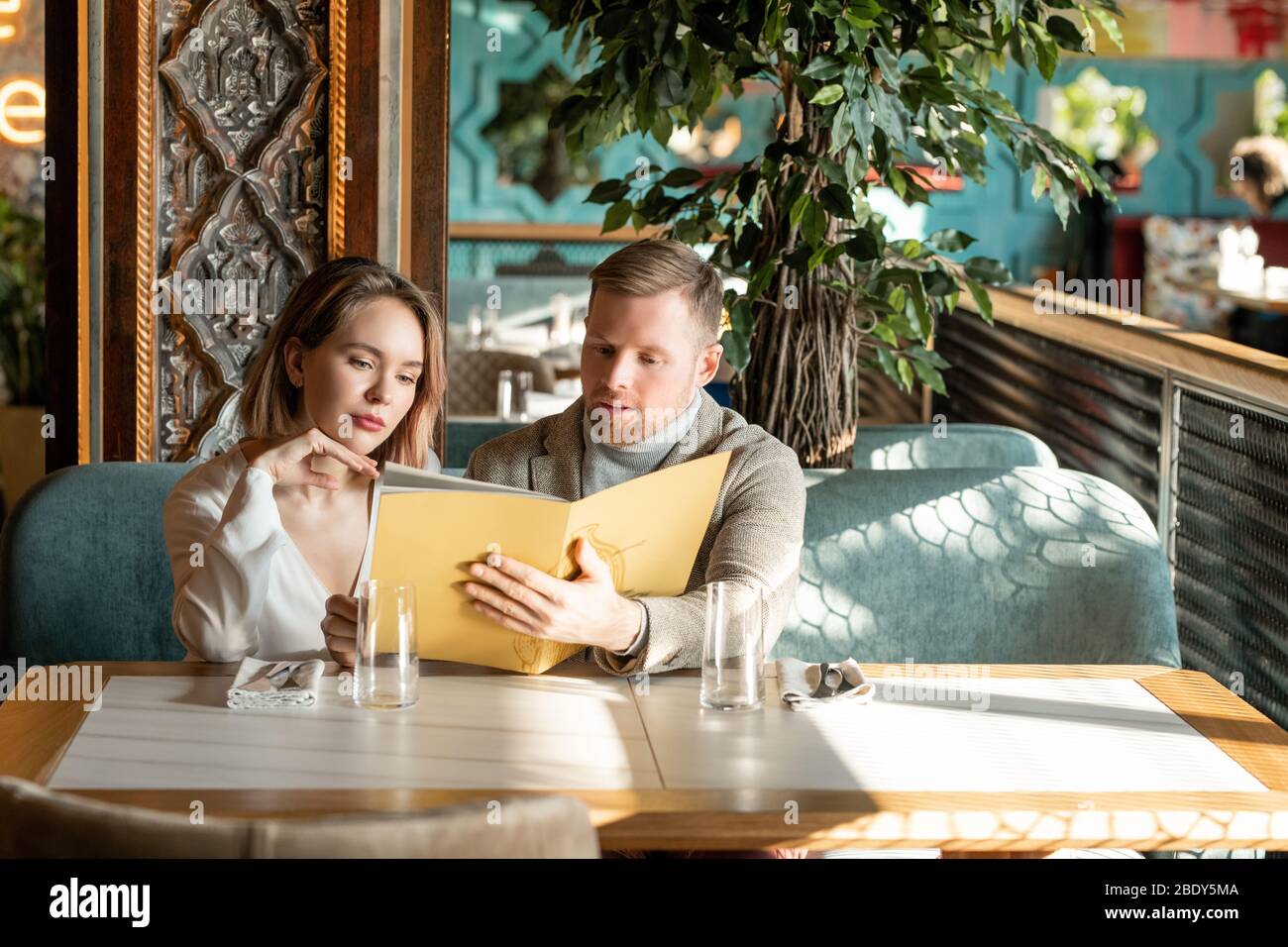 Couple looking at menu at home hi-res stock photography and images - Alamy