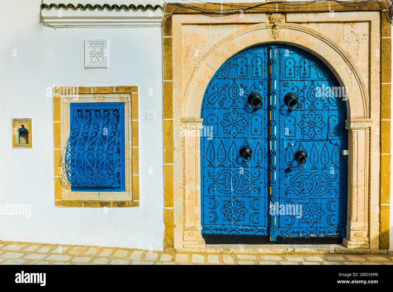 Spiked wooden door in the medina Stock Photo - Alamy
