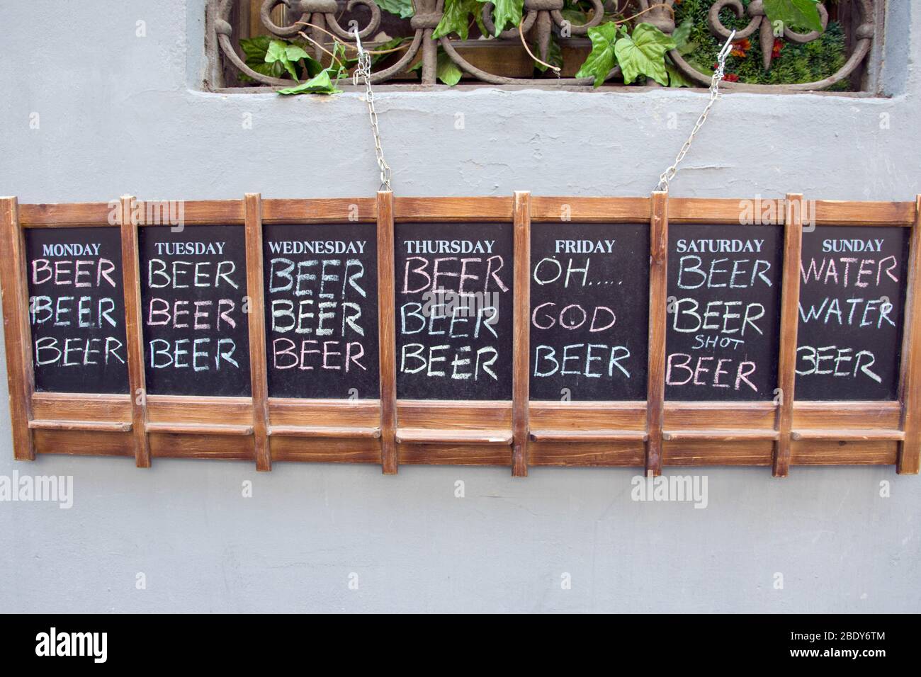 Funny hand-written sign in chalk hanged at the entrance of a bar Stock ...