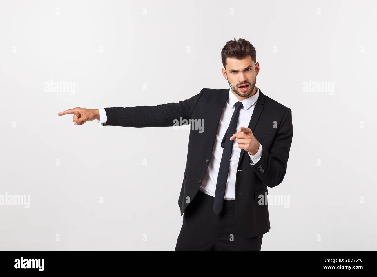 Portrait businessman angry and pointing finger at you over isolated ...