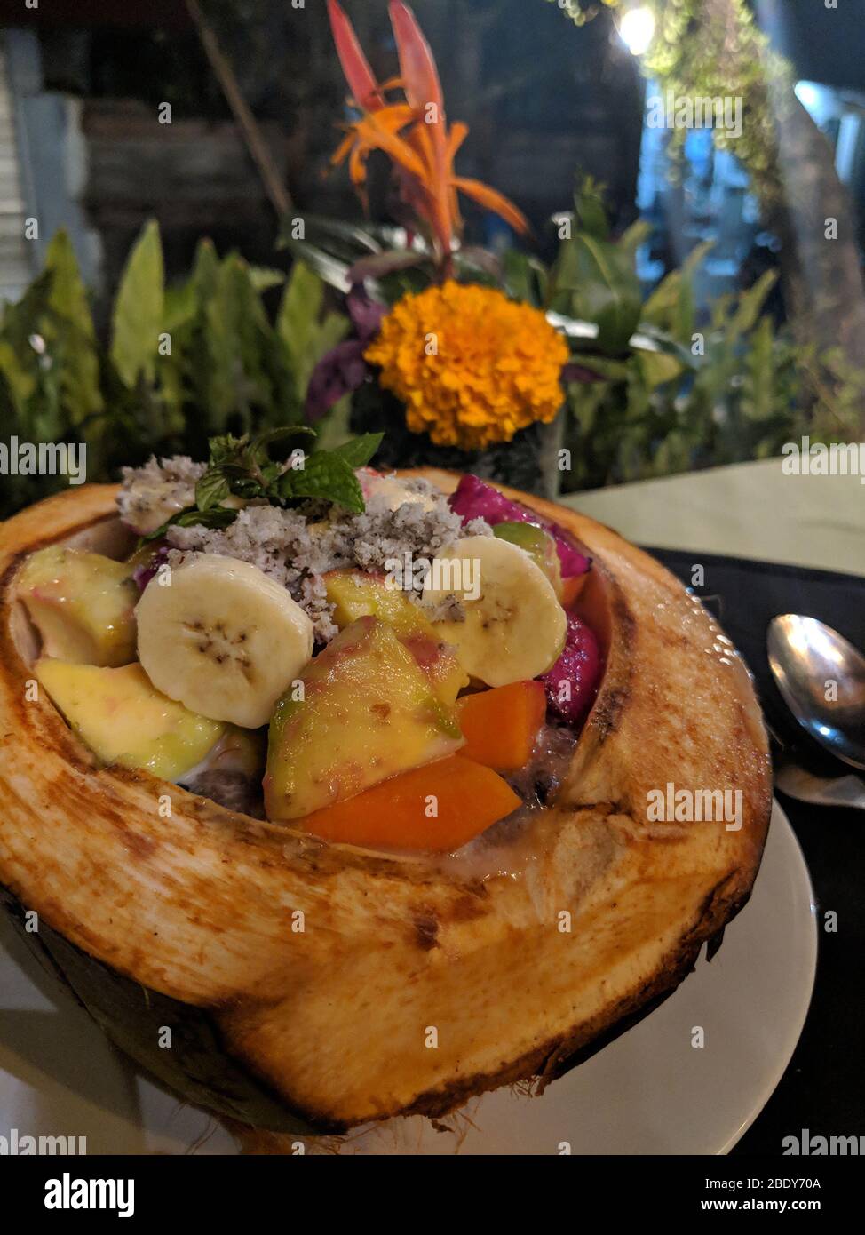 Various kinds of fruits placed inside a coconut shell. Fruit salad ...