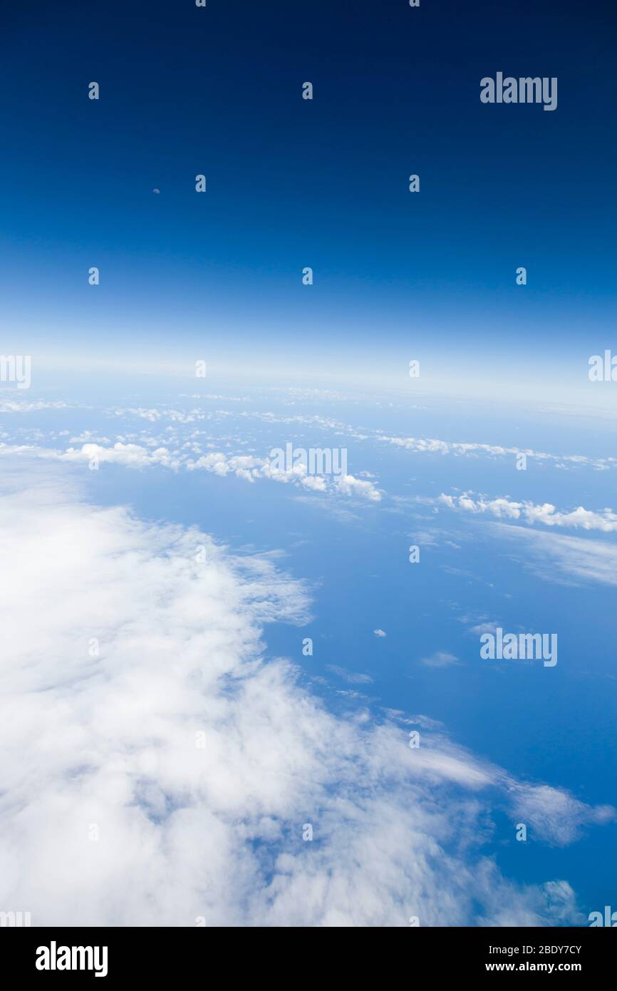 View from window of an airplane of the moon, blue sky, clouds and ...