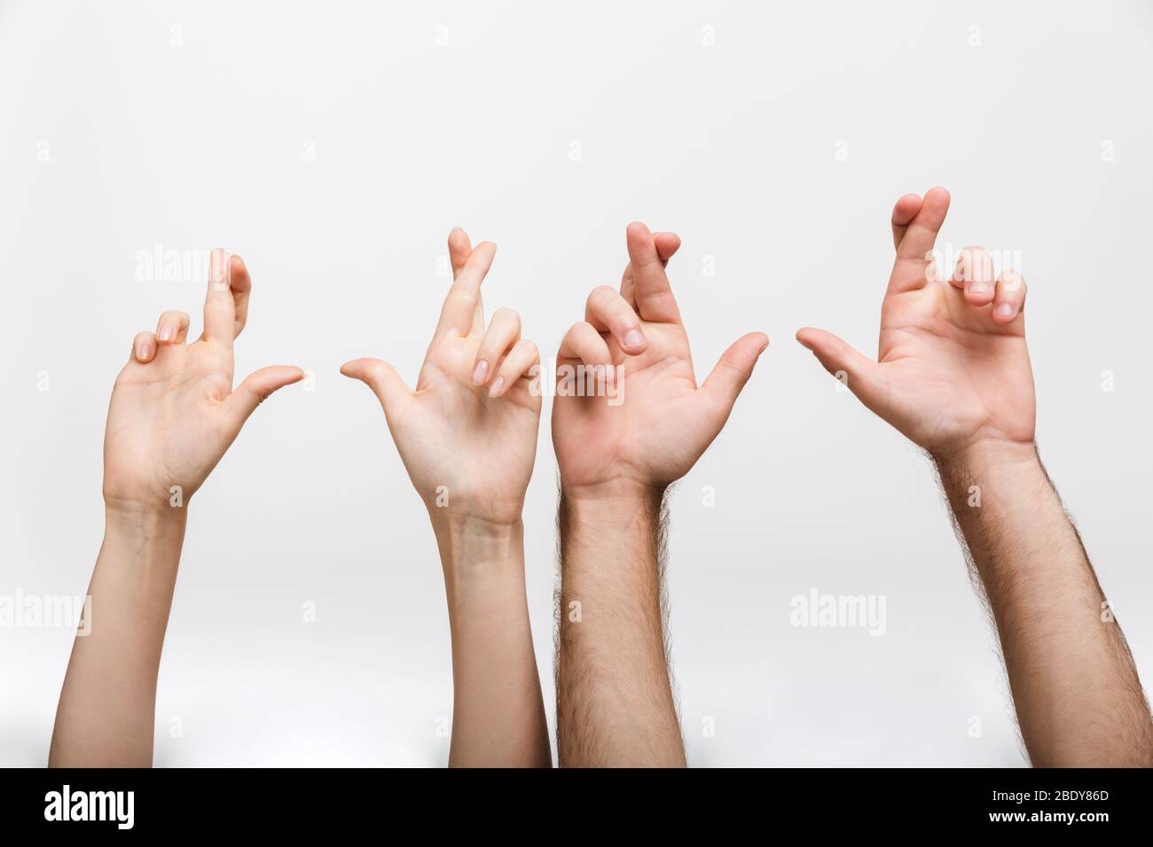 Closeup photo of a man's and woman's raised hands isolated over white ...