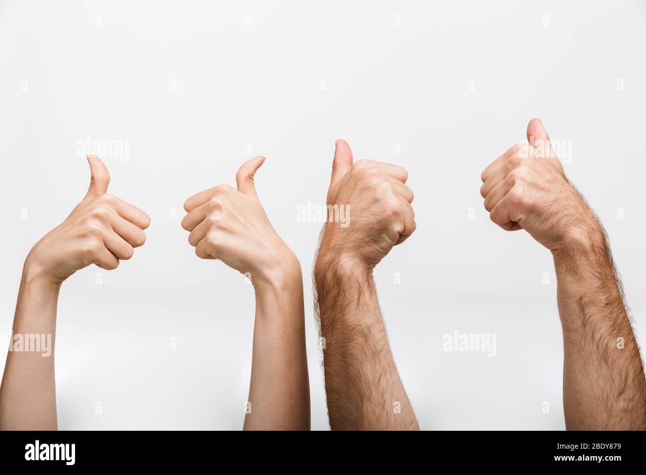Closeup image of a man's and woman's raised hands isolated over white ...
