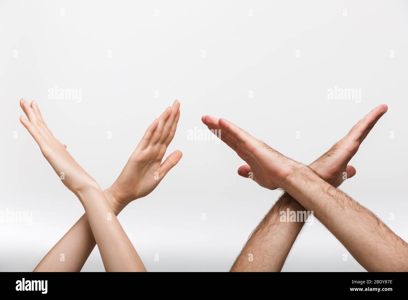 Closeup photo of a man's and woman's hands isolated over white wall ...