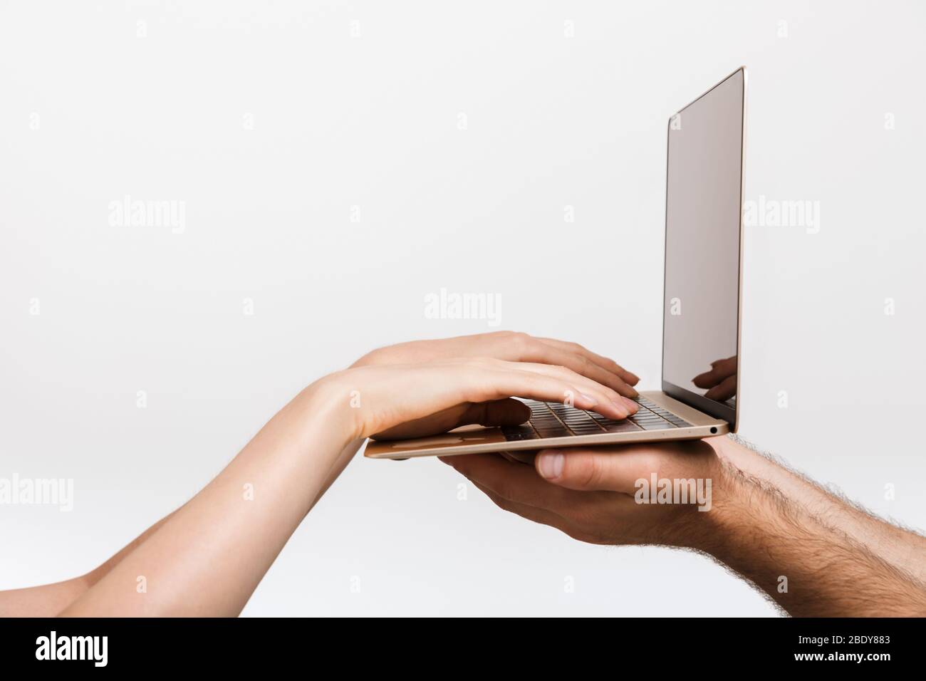 Closeup image of a man's and woman's hands isolated over white wall ...