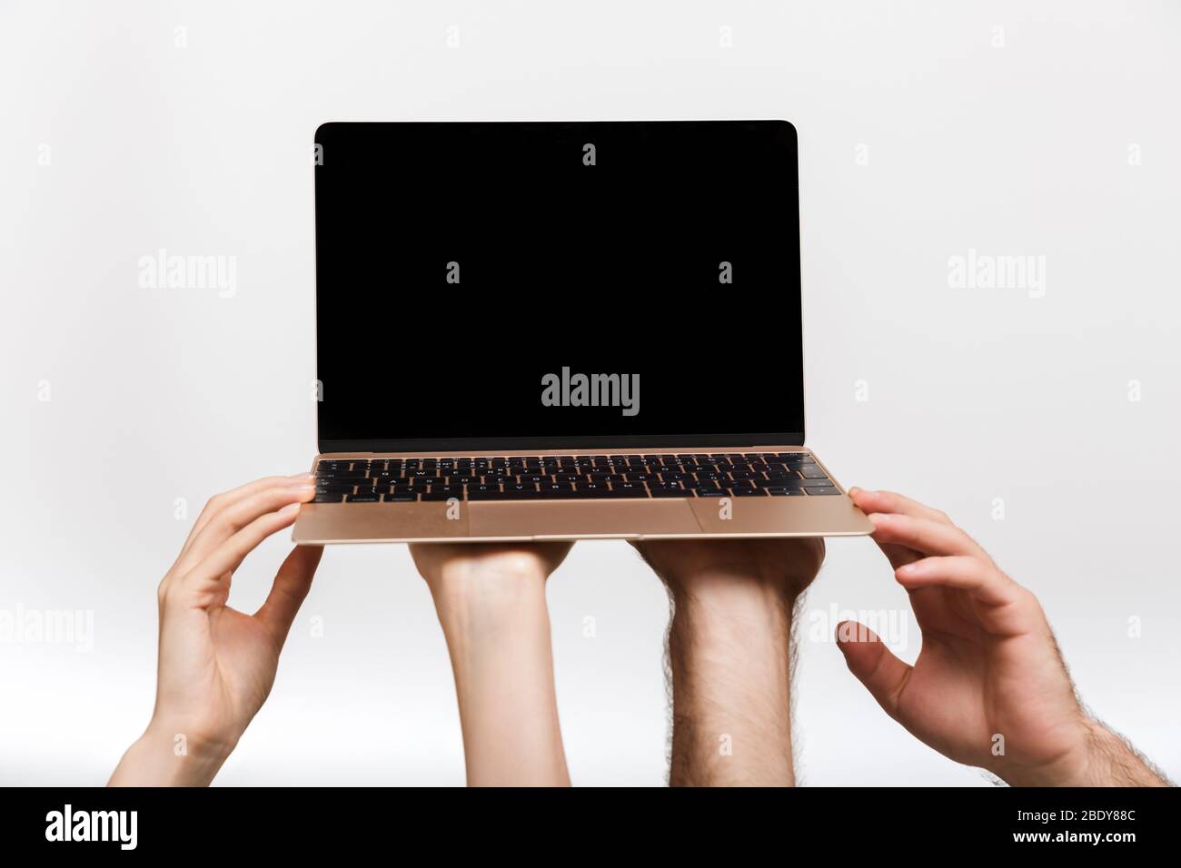 Closeup picture of a man's and woman's hands isolated over white wall ...