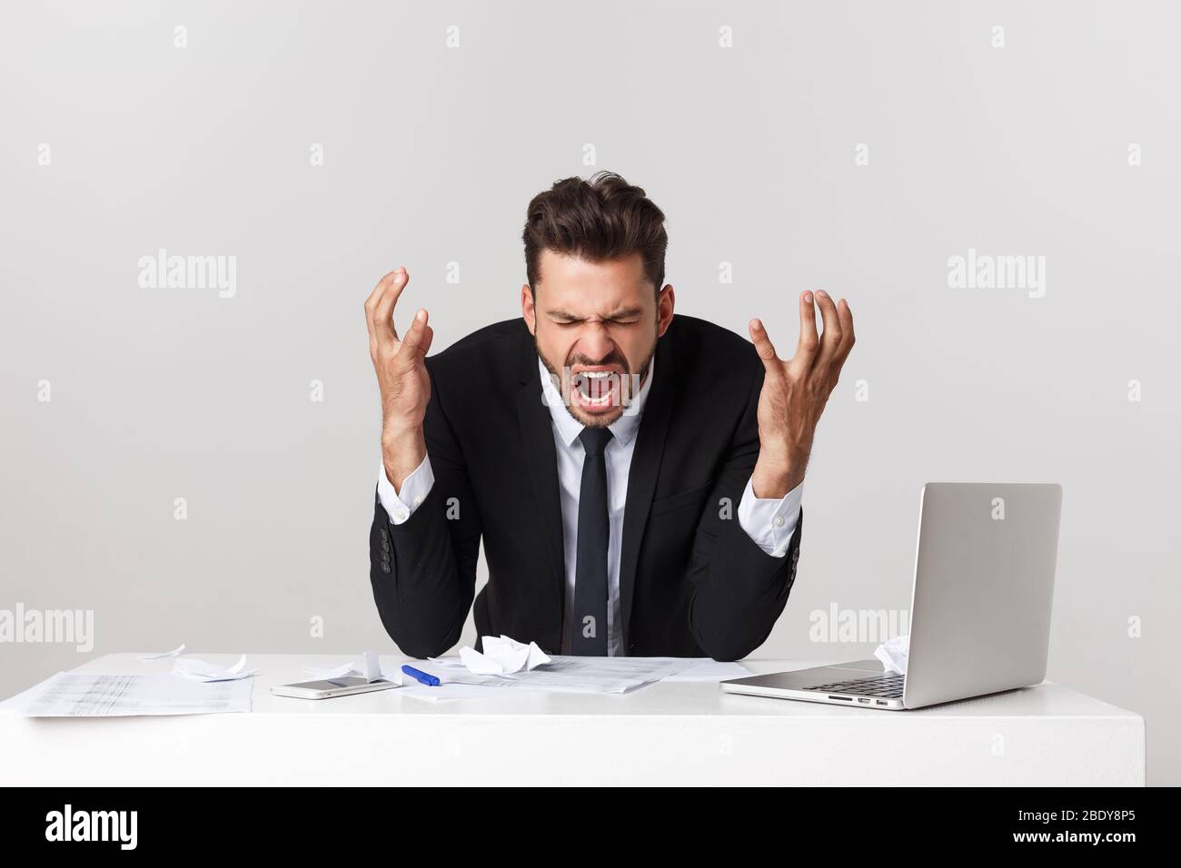 Angry and desperate caucasian entrepreneur businessman shouting at ...