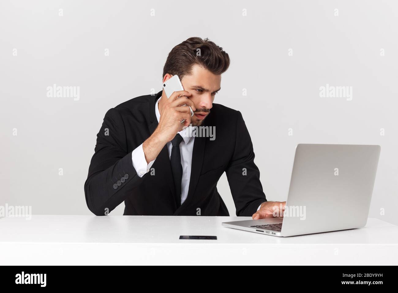 Caucasian attractive businessman worried and tired talking on mobile ...