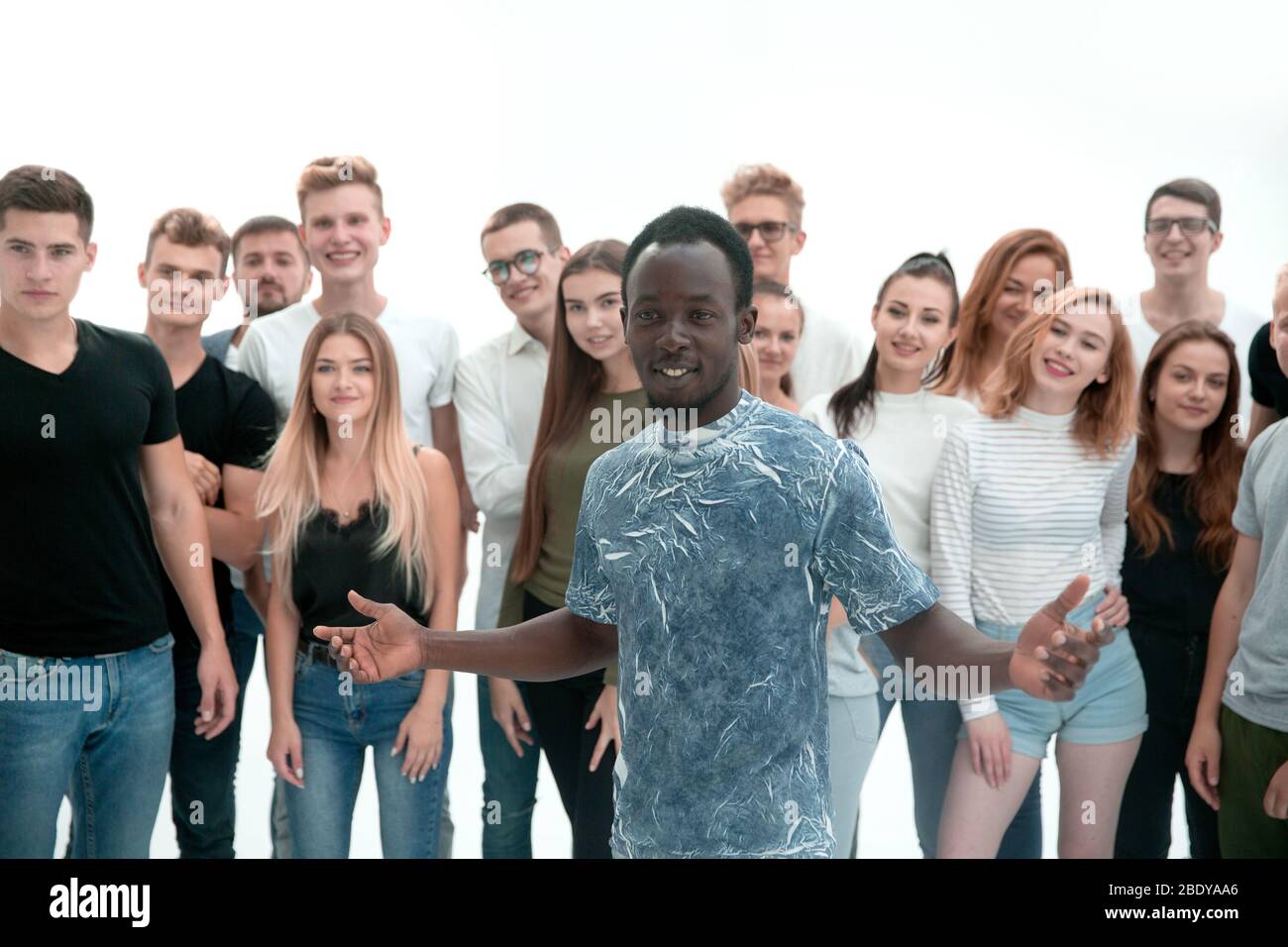 happy guy standing among a group of his friends Stock Photo - Alamy