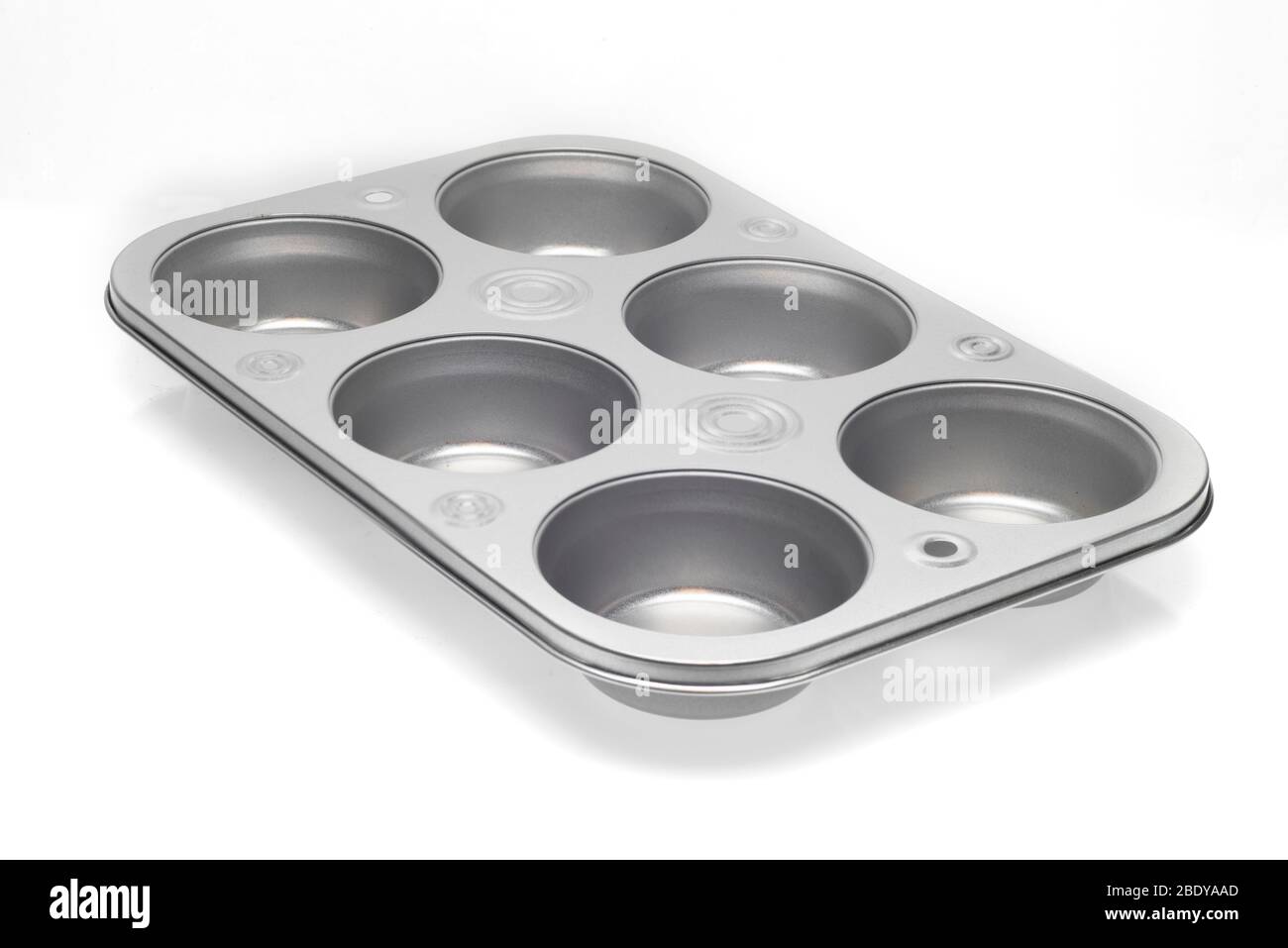 Horizontal close-up shot of an empty six-muffin muffin pan. White ...