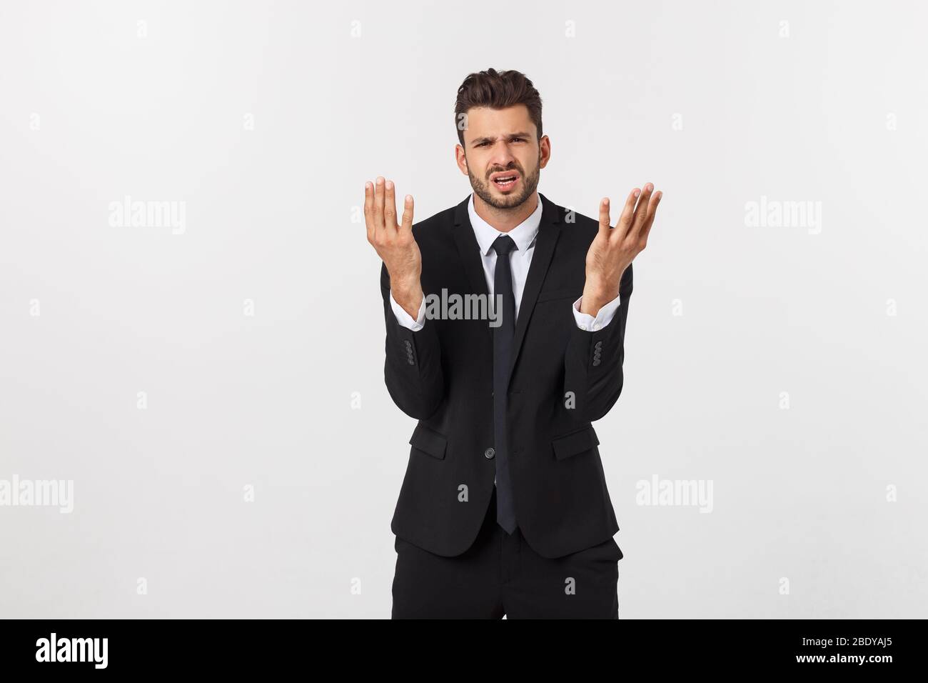Portrait of good-looking male model expressing surprise and joy raising ...